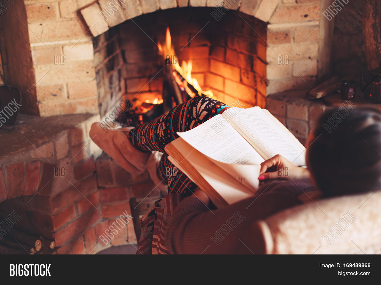 Woman Reading Book And Relaxing By The Fire Place Some Cold Evening