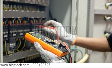 Electrician Engineer Uses A Multimeter To Test The Electrical ...