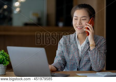 Asian Woman Talking On The Phone, She Is A Salesperson In A Startup ...