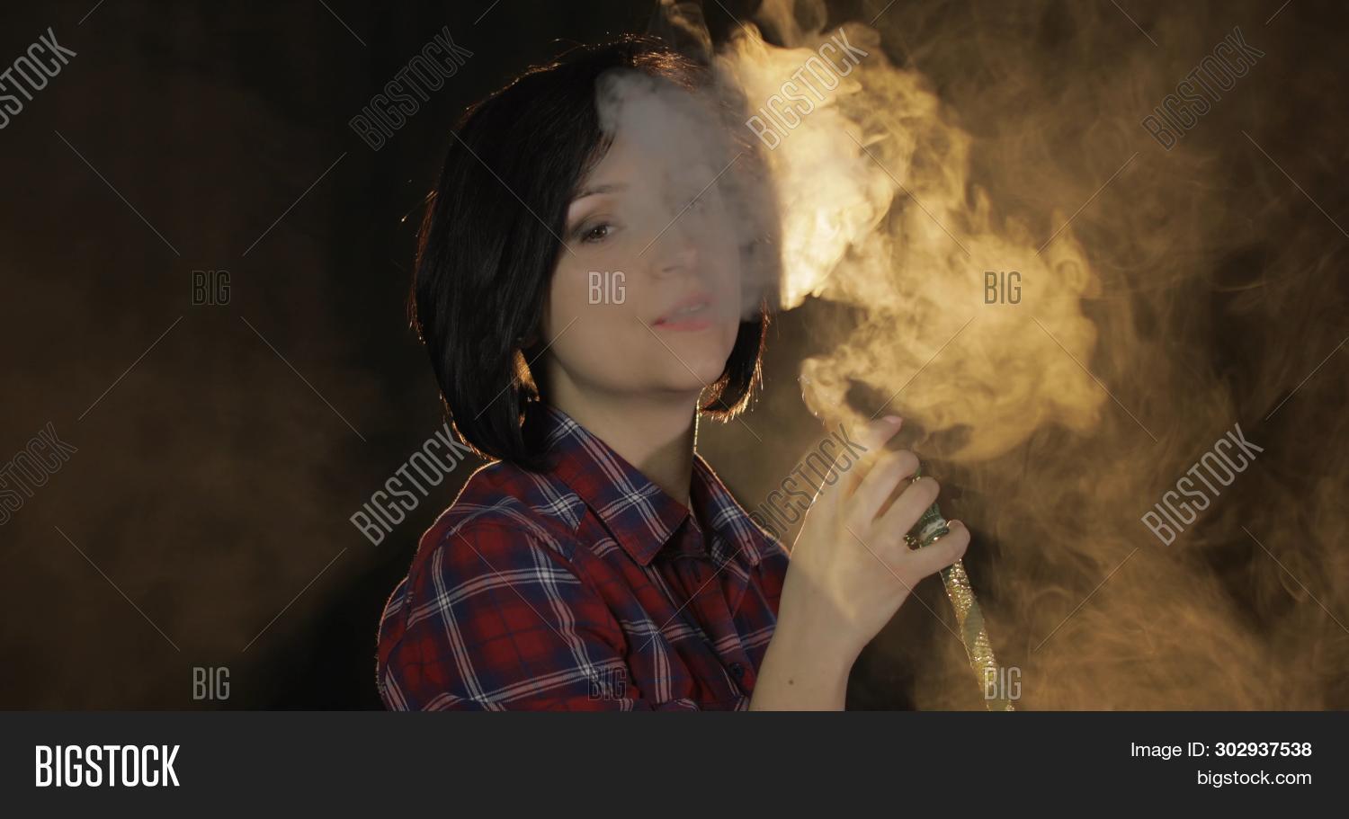 Woman Blowing Out Smoke