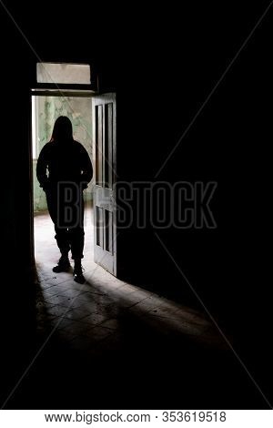 guy standing alone in dark