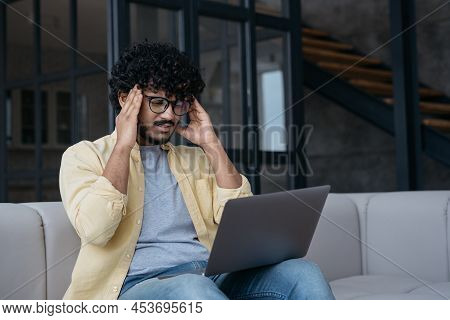 Tired Stressed Indian Businessman Using Laptop Having Headache Sitting ...