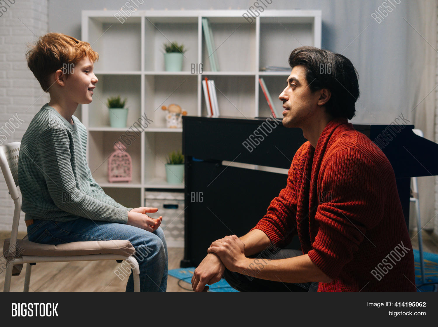 Father Talking To A Man And Boy