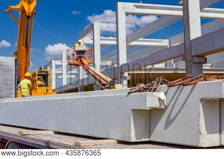 Trailer Truck Is At Unloading Cargo, Concrete Beam For Assembling ...