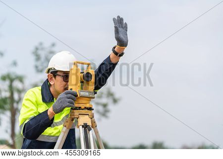 Surveyor Civil Engineer Hand Signal With Equipment On The Construction ...