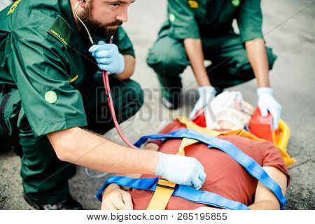Paramedic team rescuing a critical patient - Stock Image - Everypixel