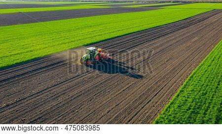 Above View, Of Tractor As Pulling Mechanical Seeder Machine Over Arable ...