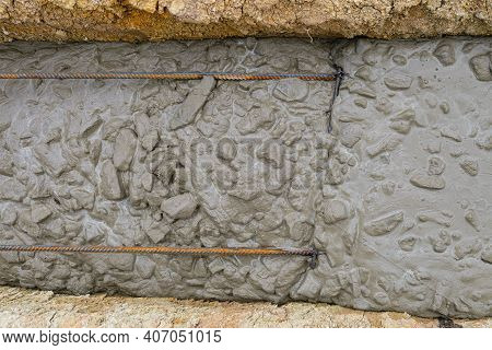Freshly Poured Reinforced Concrete In A Trench. Construction Of A ...