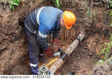 A Man In Working Form Is Working On Production, Factory Physical Labor ...