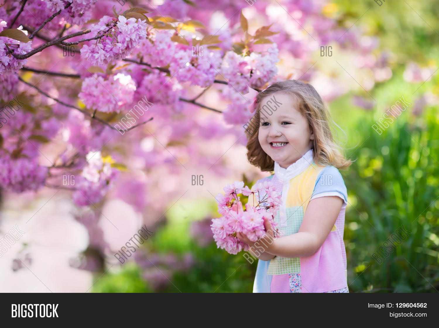 Happy Little Girl With Flower