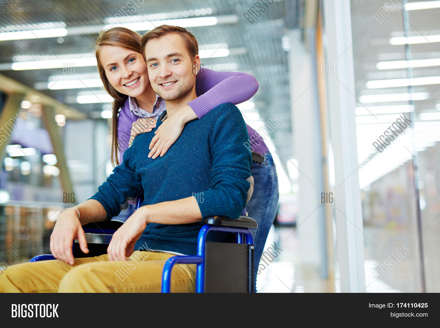 Portrait of young happy couple: pretty girl hugging her smiling ...