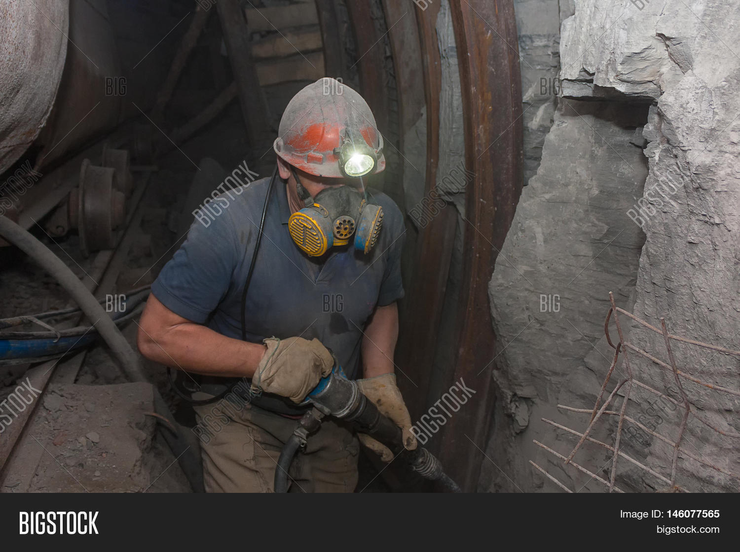 Miner in a respirator with a jackhammer in underground coal mines Stock ...