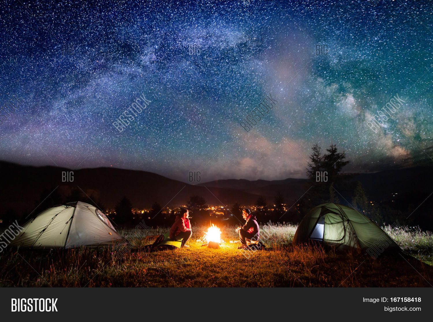 Romantic Couple Sitting At Campfire Near Tents In The Night Stock Photo ...