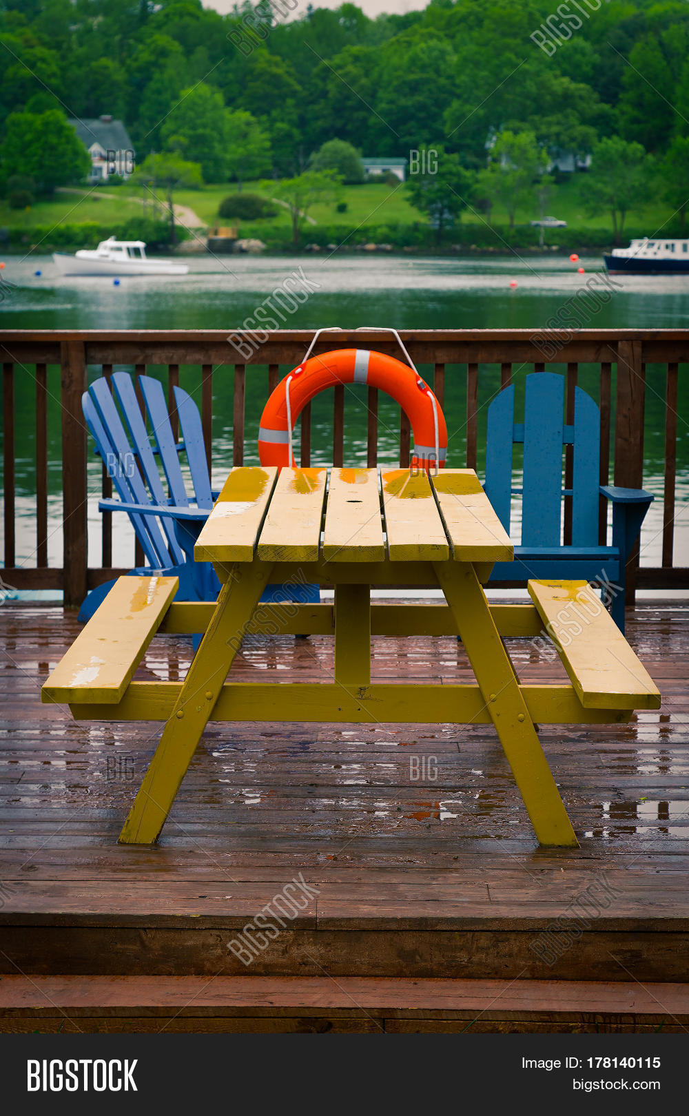Decorative metal park benches overlooking still water. Stock Photo ...